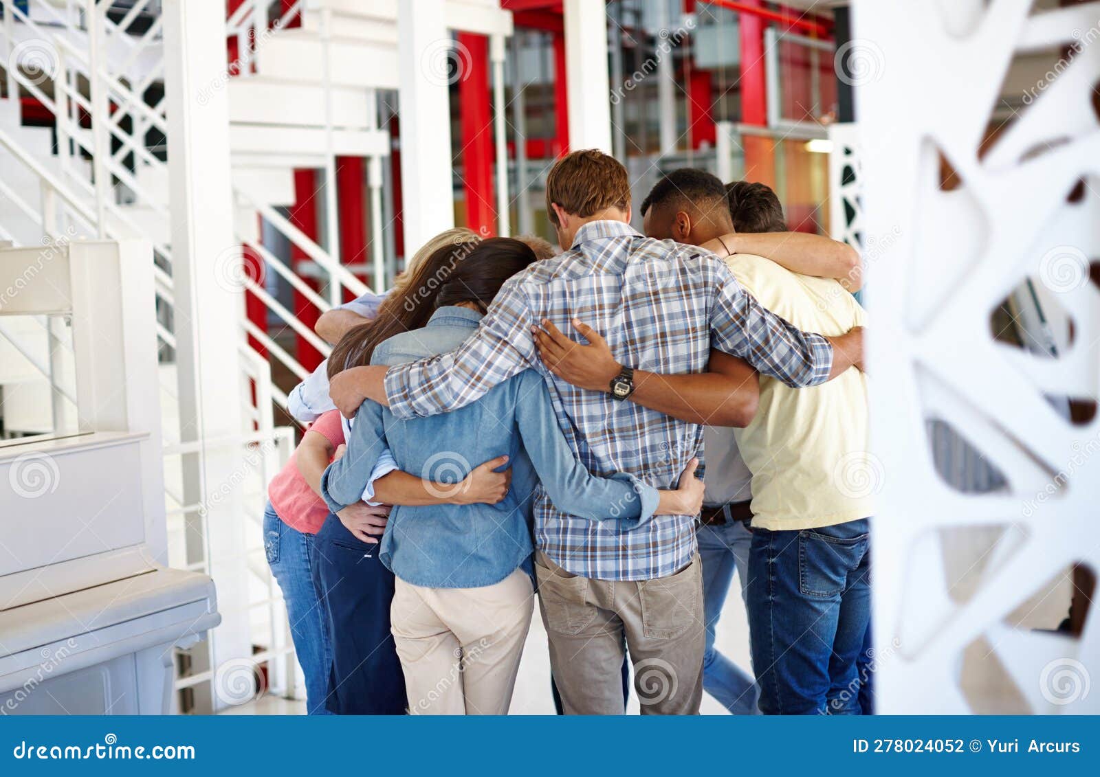 This Team Beats with One Heart. a Group of Coworkers Huddled Together ...