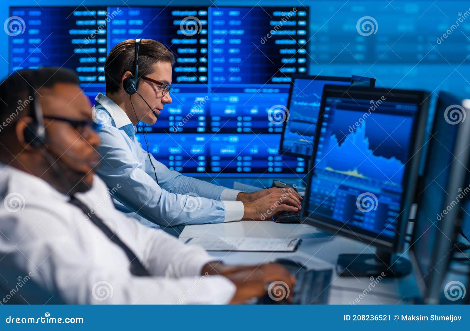 Team of Brokers is Working in Office Using Workstation and Analysis ...