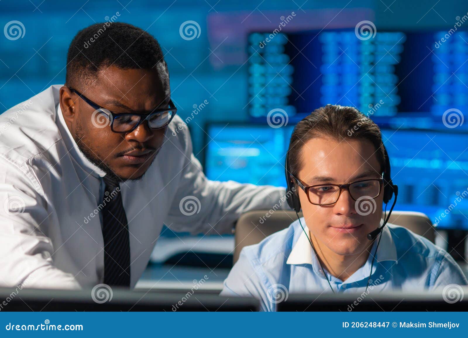 Team of Brokers is Working in Office Using Workstation and Analysis ...