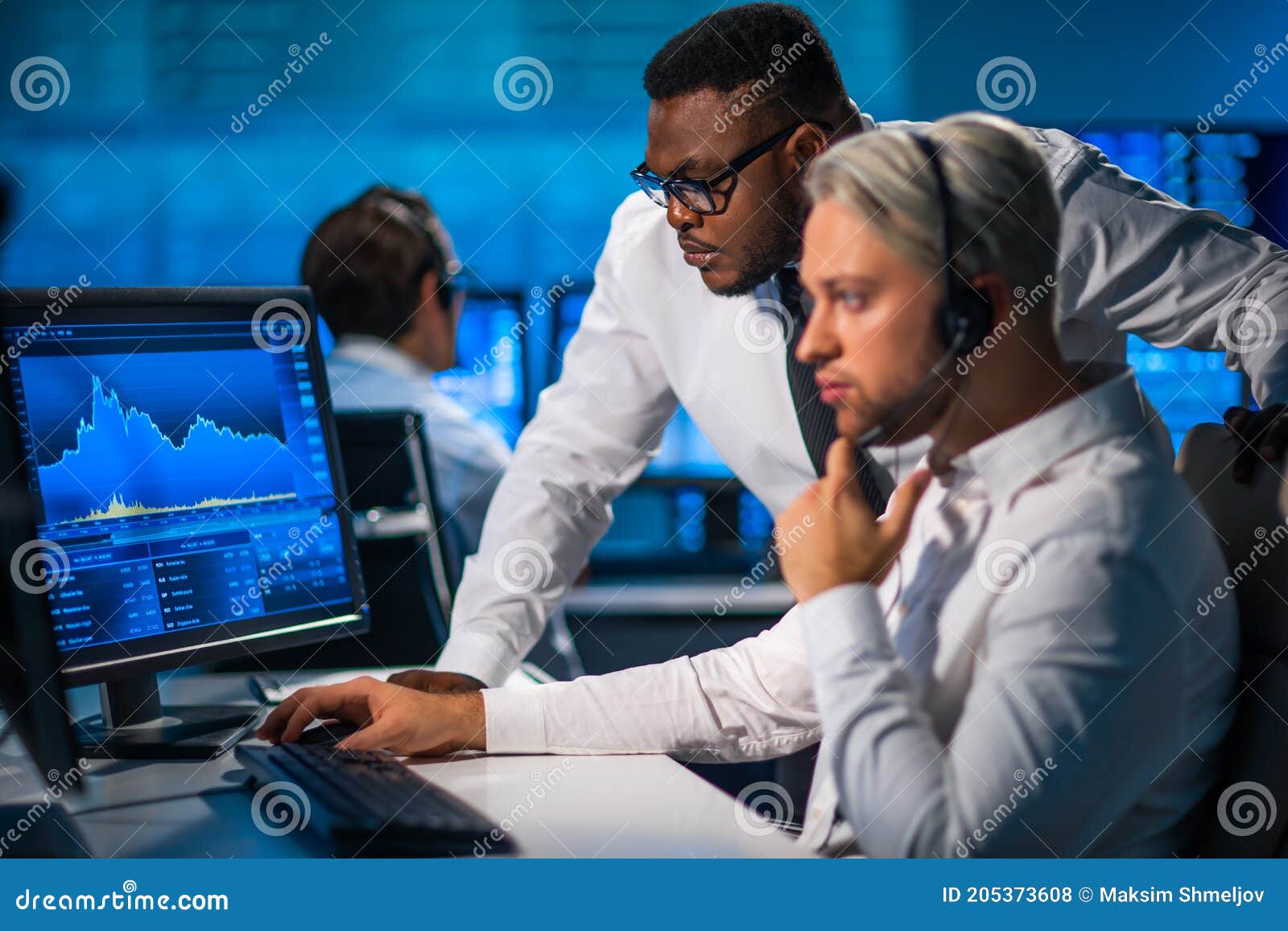 Team of Brokers is Working in Office Using Workstation and Analysis ...