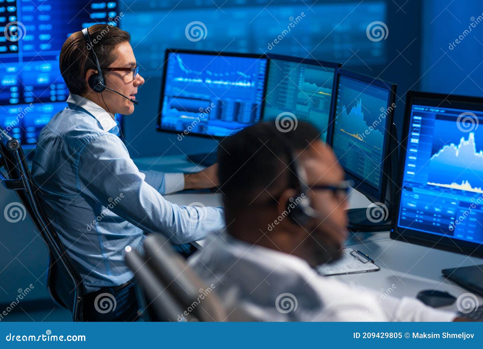 Team of Brokers is Working in Office Using Workstation and Analysis ...