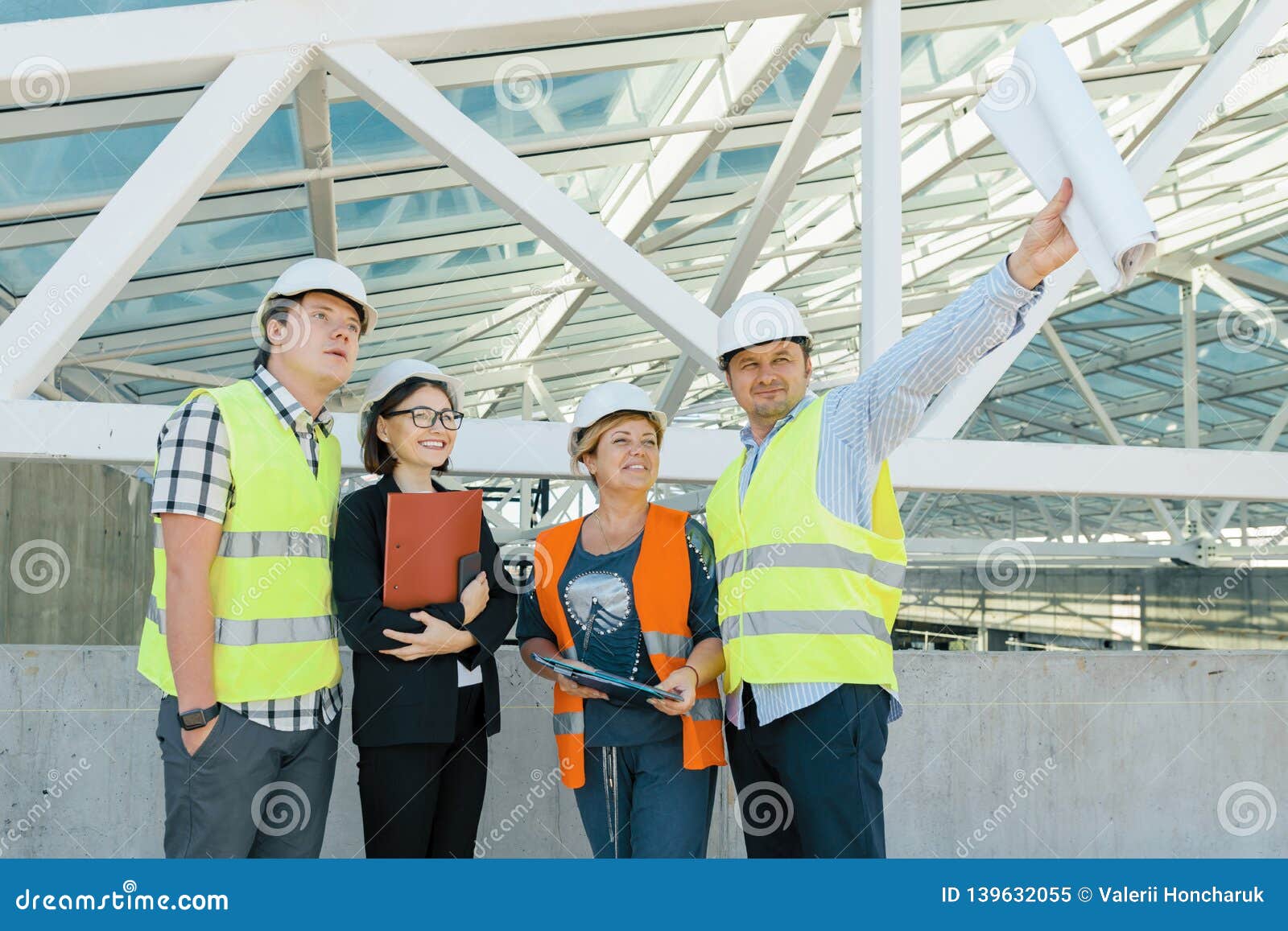 Team of Builders Engineer Architect on the Roof of Construction Site ...