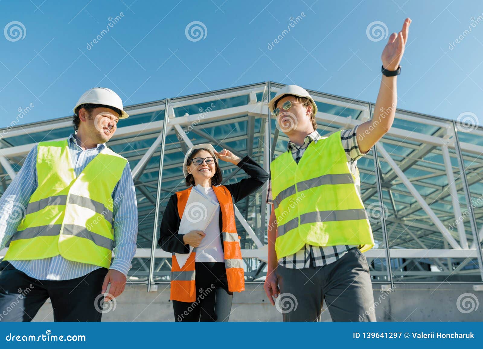 Team of Builders Engineer Architect on the Roof of Construction Site ...
