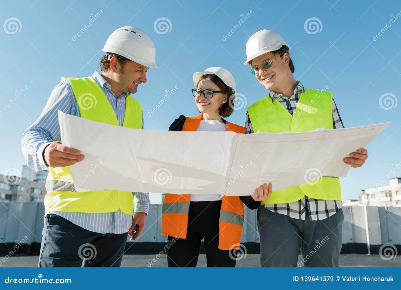 Team of Builders Engineer Architect on the Roof of Construction Site ...