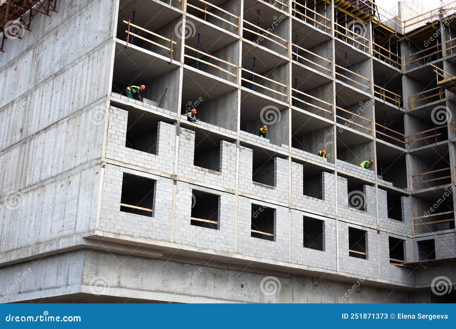 A Team Of Builders Make A Wall Of Foam Concrete In A Multi-storey ...