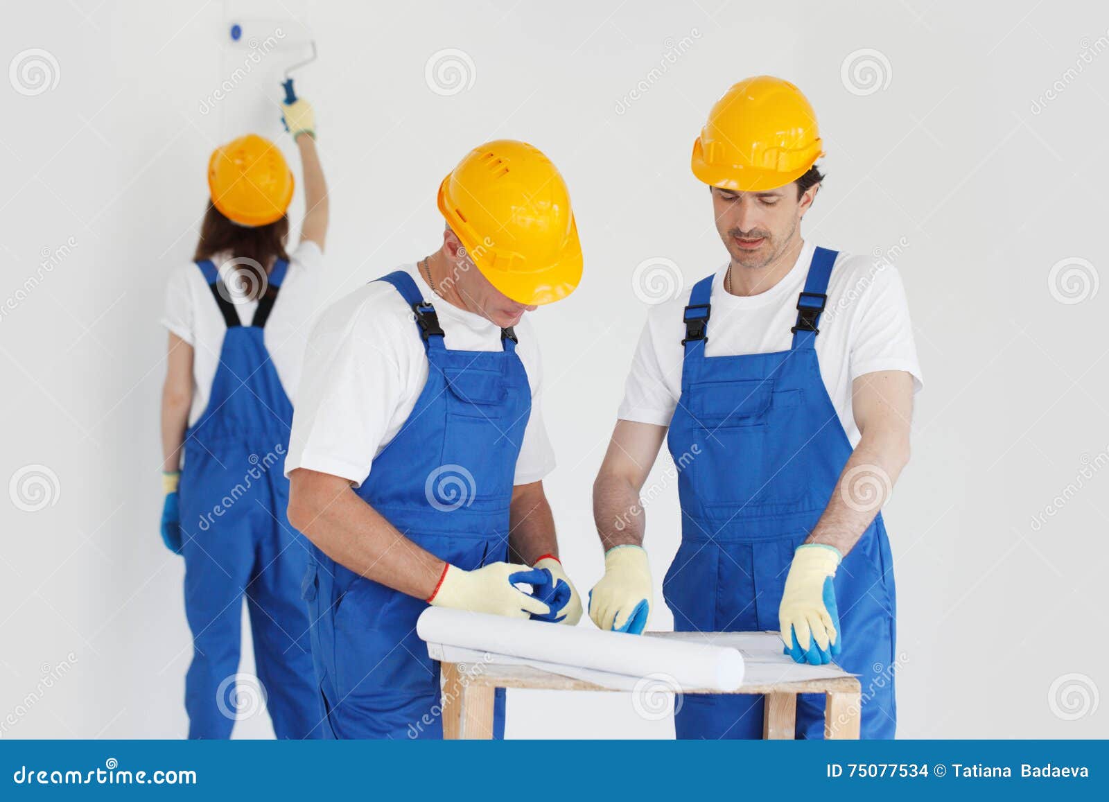 Team of buildres with plan stock photo. Image of group - 75077534