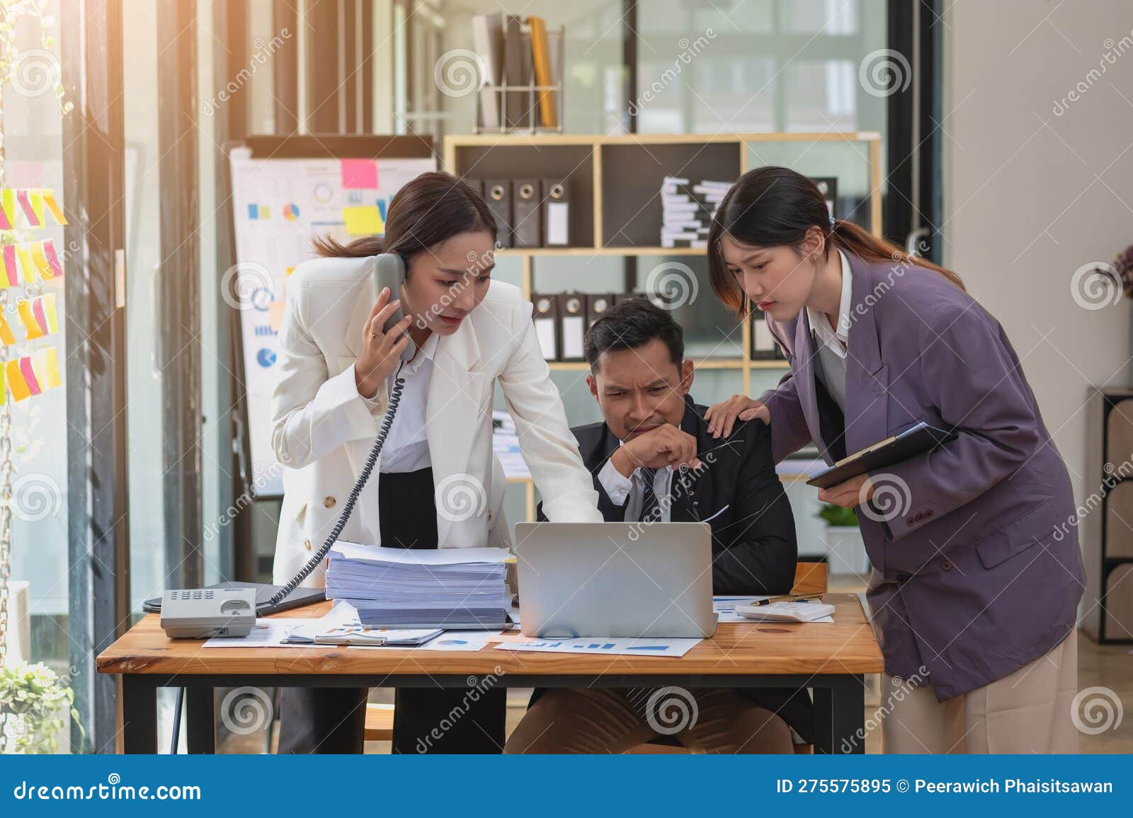 A Team of Business People are Busy Working on the Phone. Laptop ...
