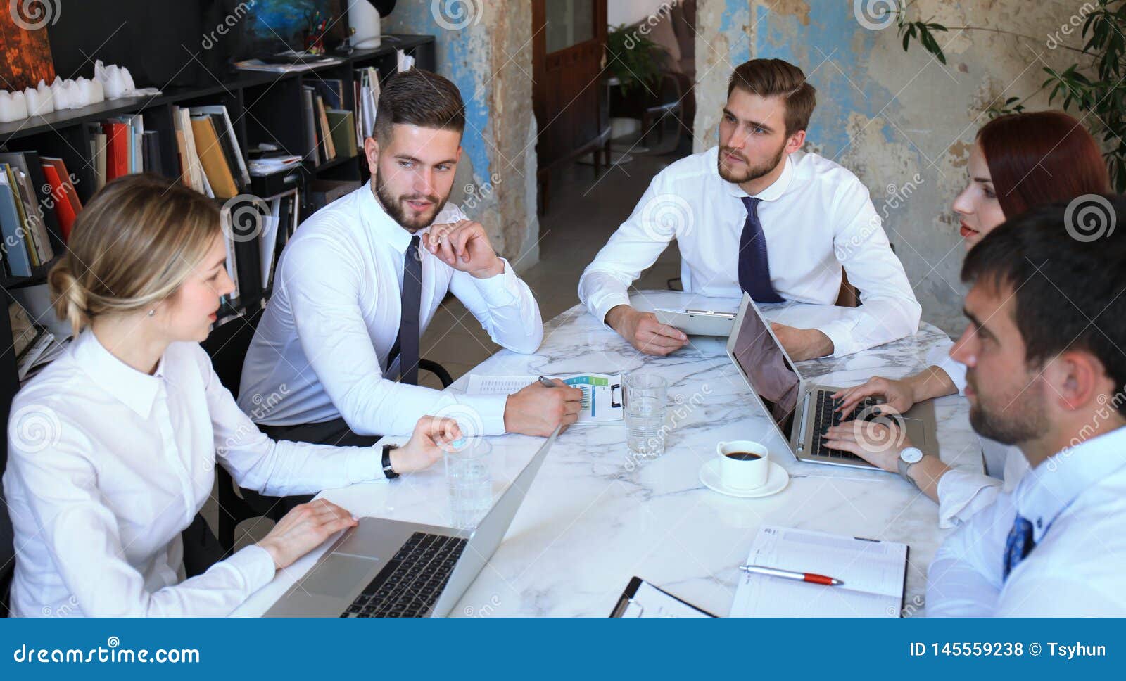 Team of Business People Having Discussion at Table in Creative Office ...