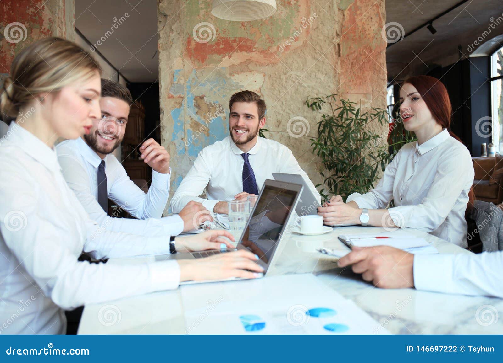 Team of Business People Having Discussion at Table in Creative Office ...