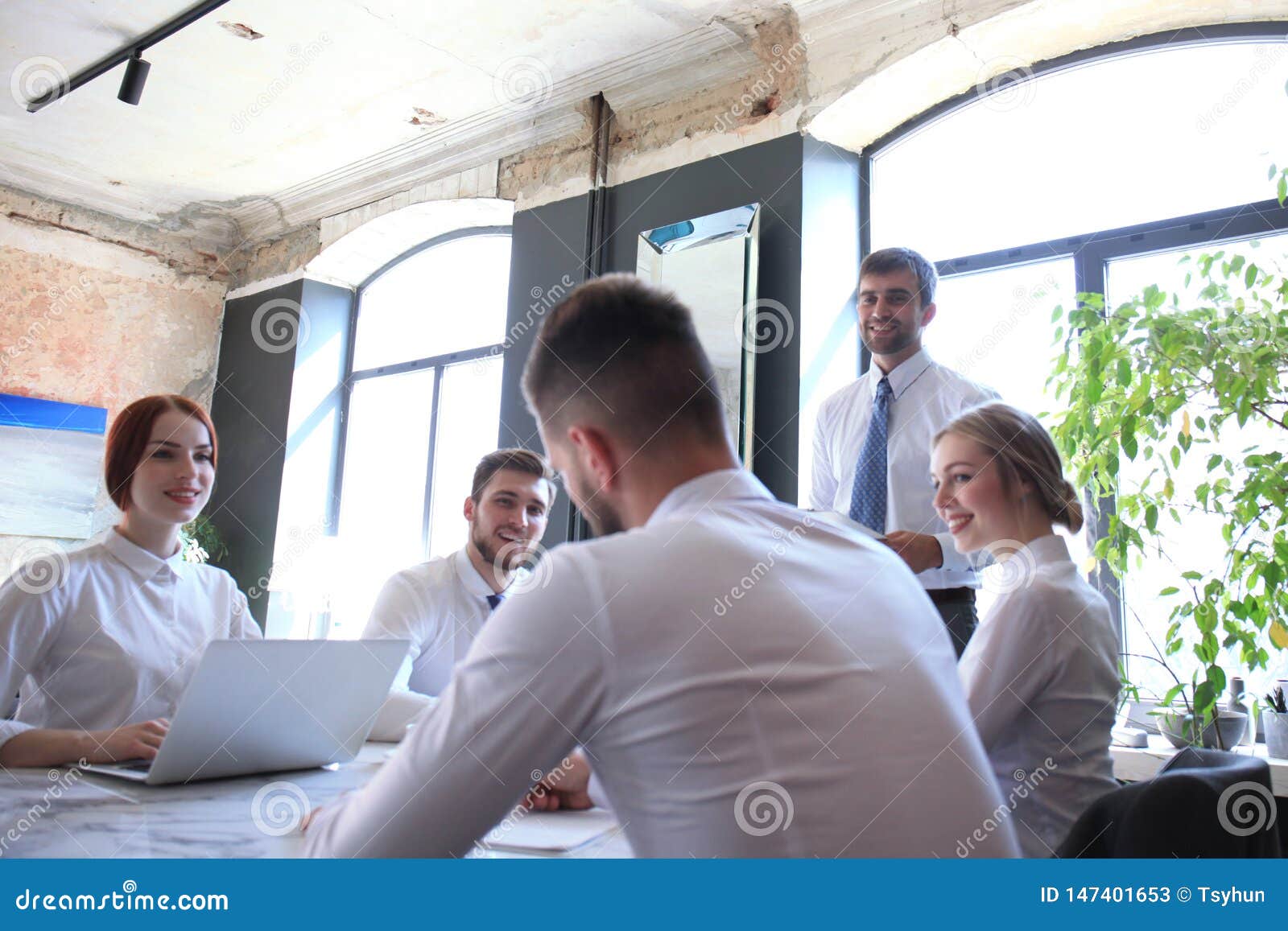 Team of Business People Having Discussion at Table in Creative Office ...