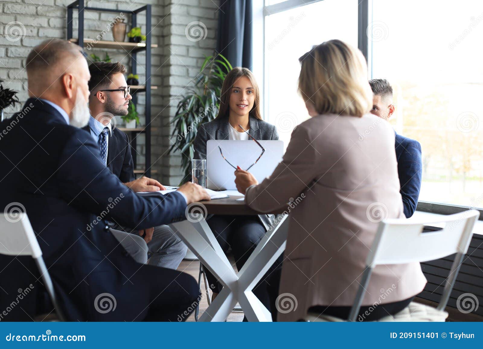 Team of Business People Having Discussion at Table in Creative Office ...
