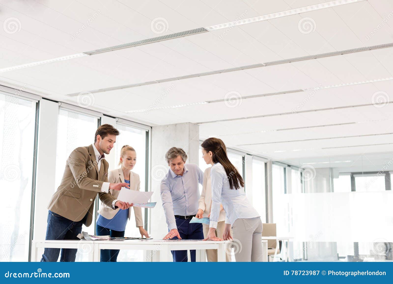 Team of Business People Having Discussion at Table in New Office Stock ...