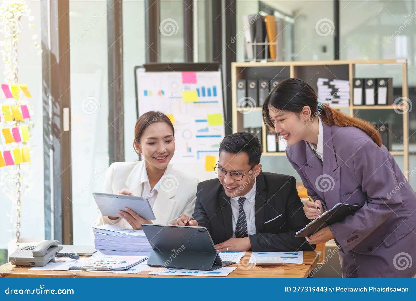 Team Business Three Smiling and Happy Asian Men and Women Team Using ...