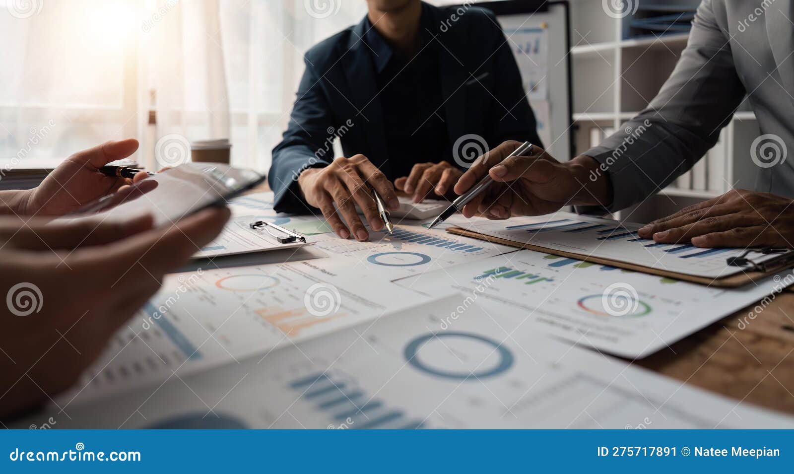 Team Business Using a Calculator and Tablet To Calculate the Numbers of ...