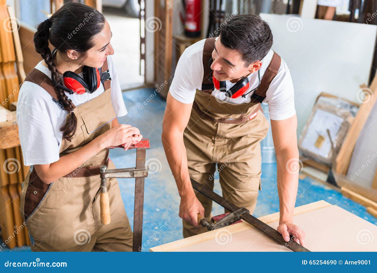 Team of Carpenters Comparing Work Pieces Stock Photo - Image of ...