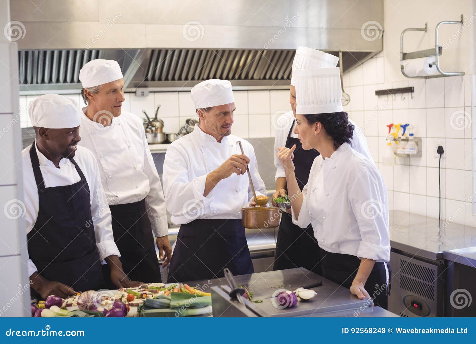 Team of Chef Tasting Food in the Commercial Kitchen Stock Photo - Image ...
