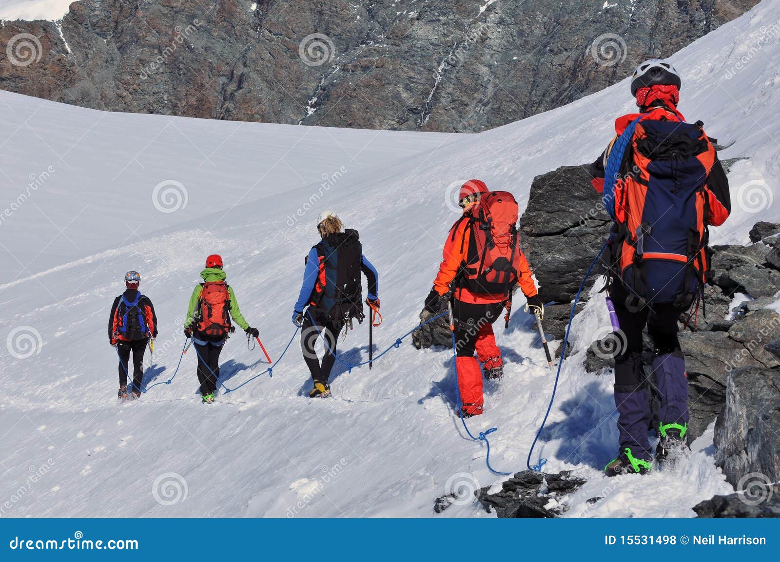 Team Of Climbers Man And Woman Hiker Holding Hands To Help Each Other ...