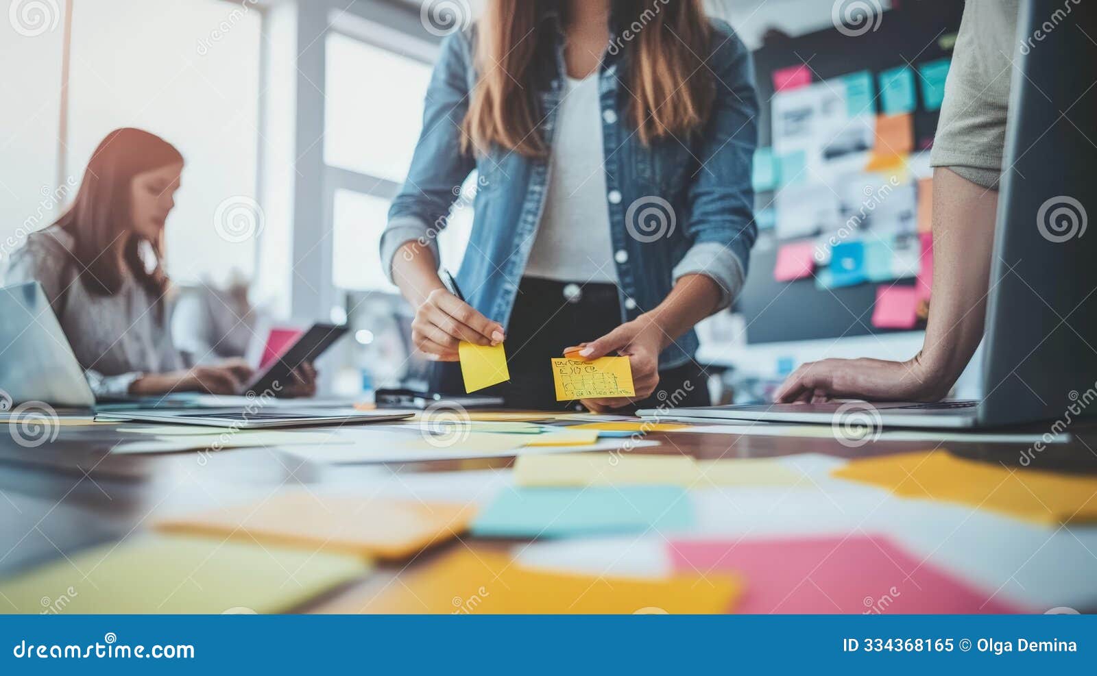 Team Collaborating with Sticky Notes and Digital Devices in a Modern ...