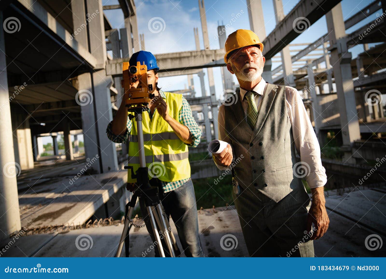 Team of Construction Engineers, Architects Working on Building Site ...