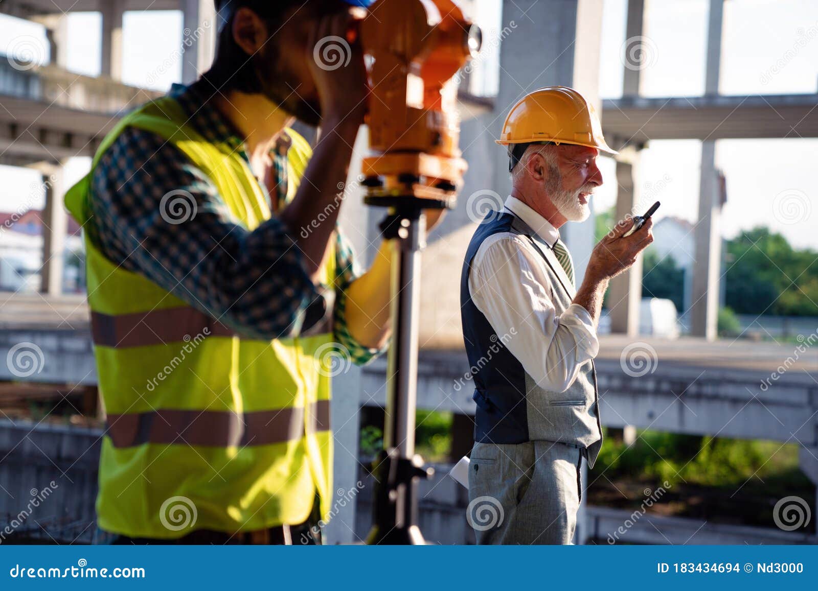 Team of Construction Engineers, Architects Working on Building Site ...