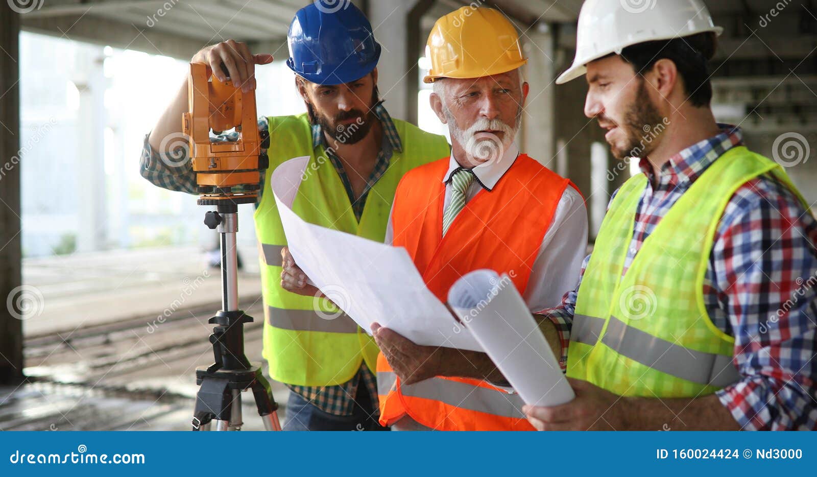 Team of Construction Engineers, Architects Working on Building Site ...