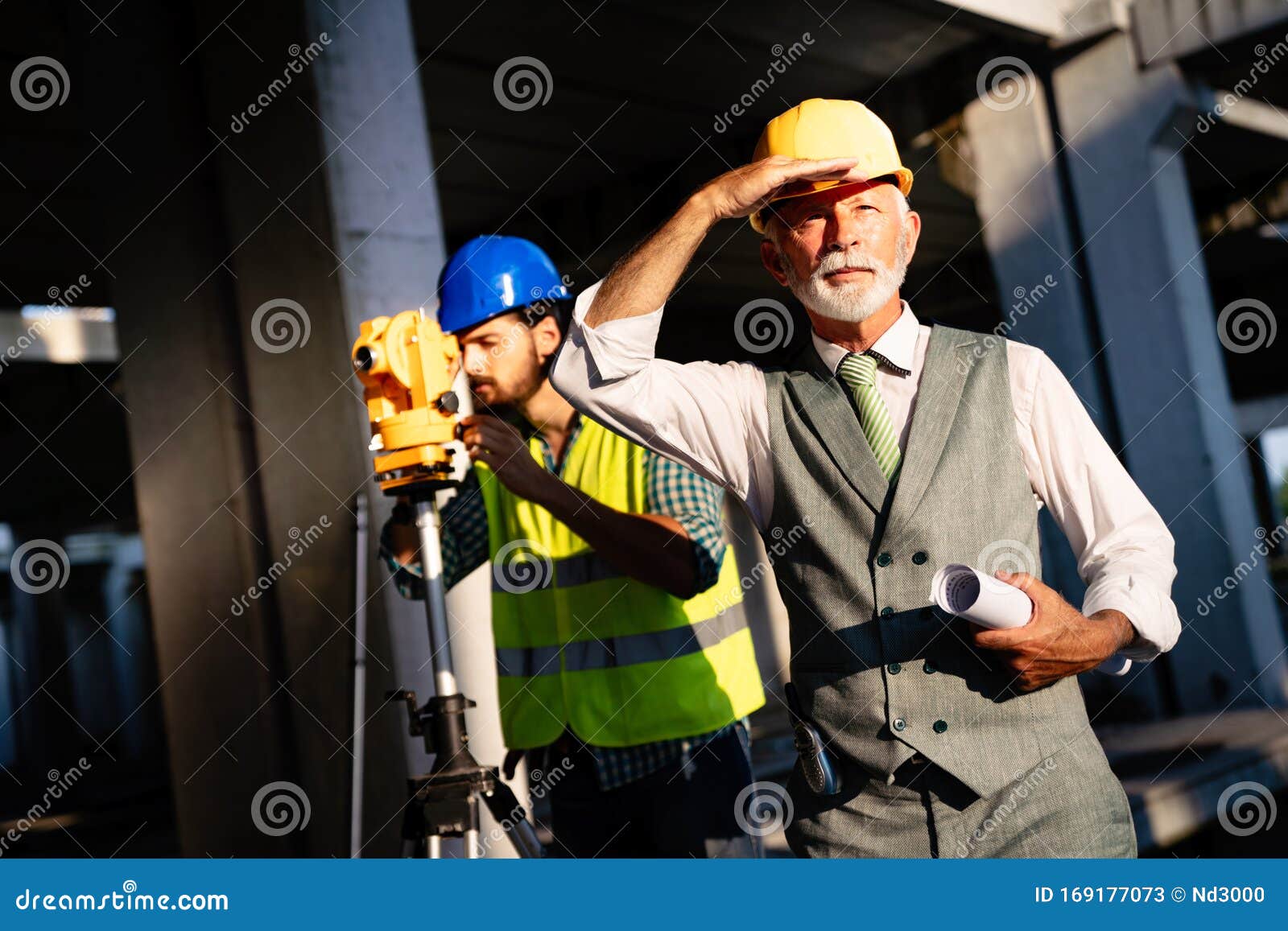 Team of Construction Engineers, Architects Working on Building Site ...