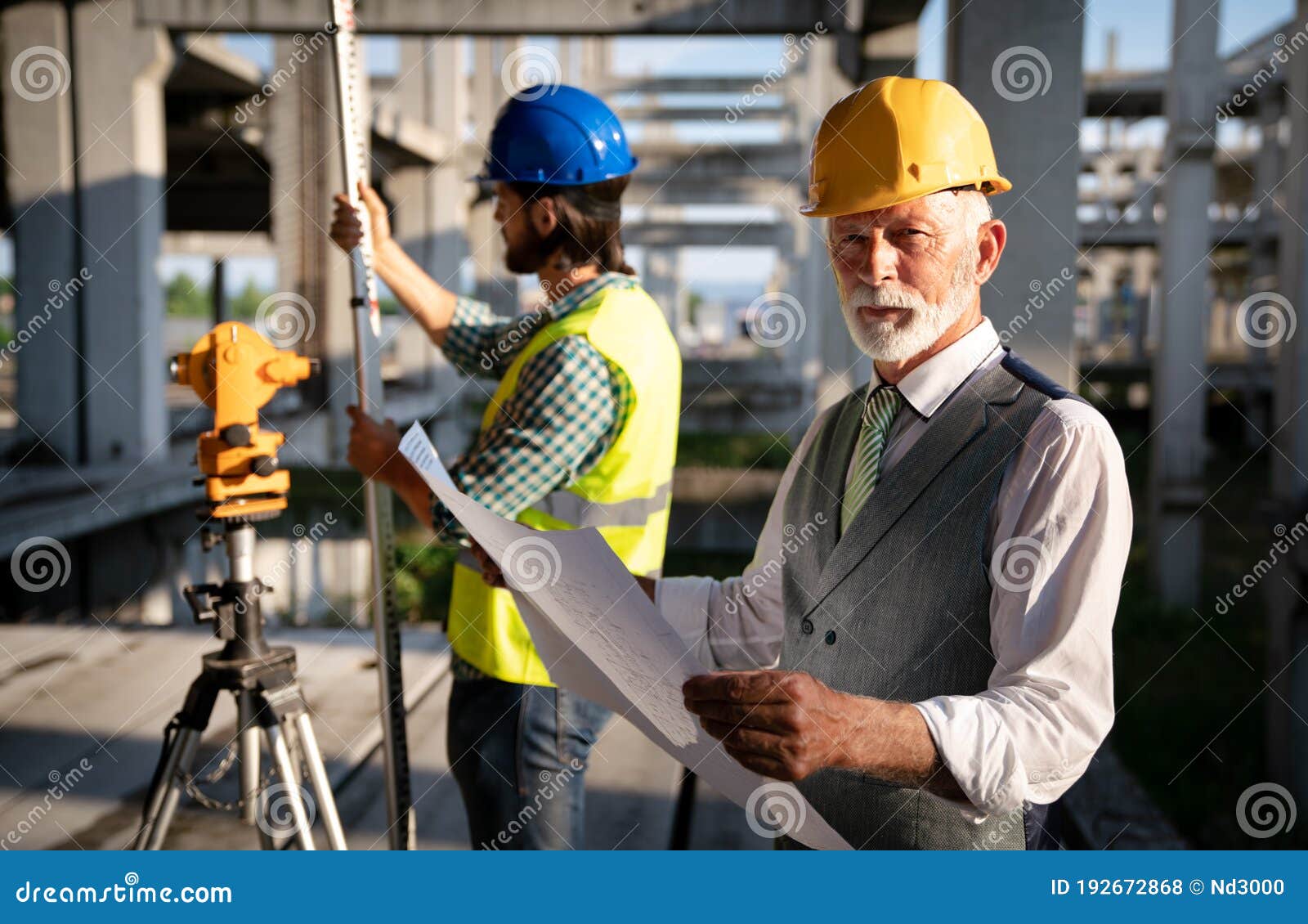 Team of Construction Engineers, Architects Working on Building Site ...