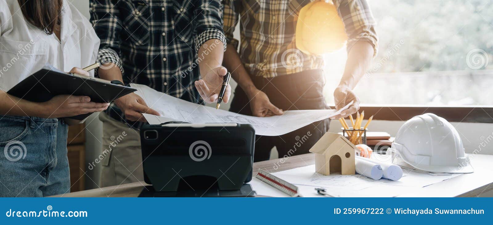 Team Construction Engineers Working at Construction Site with Blueprint ...