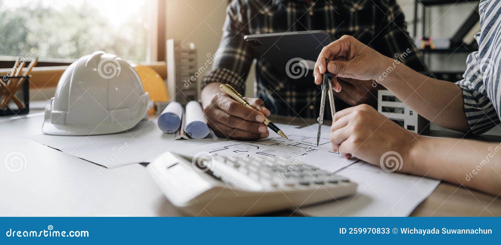 Team Construction Engineers Working at Construction Site with Blueprint ...