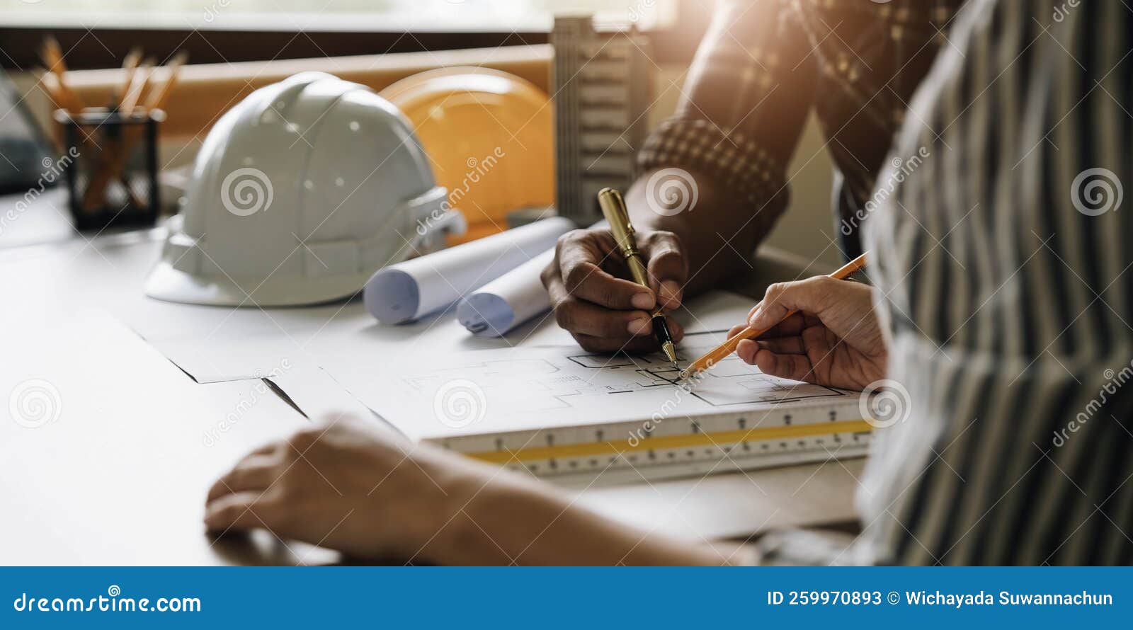 Team Construction Engineers Working at Construction Site with Blueprint ...