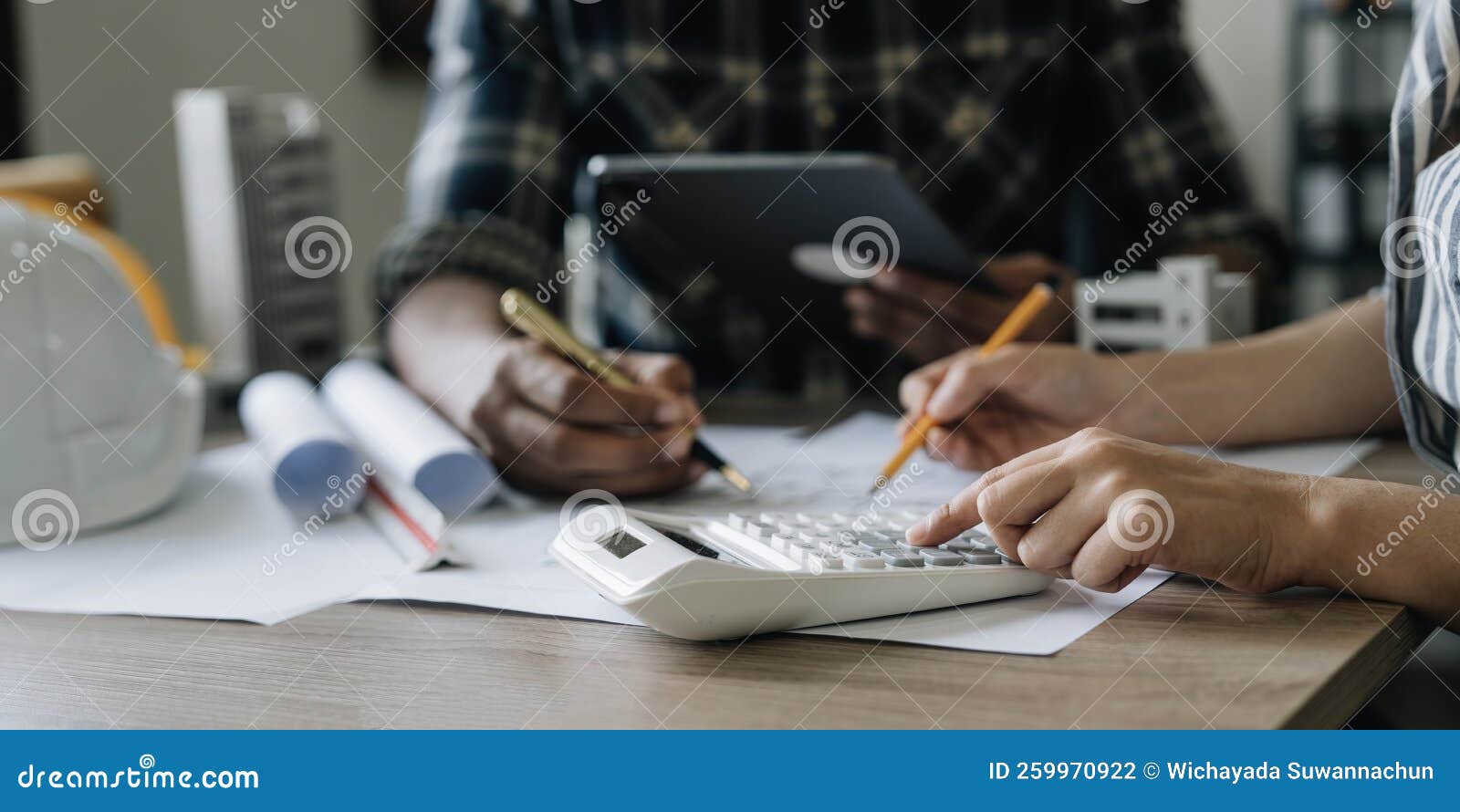 Team Construction Engineers Working at Construction Site with Blueprint ...