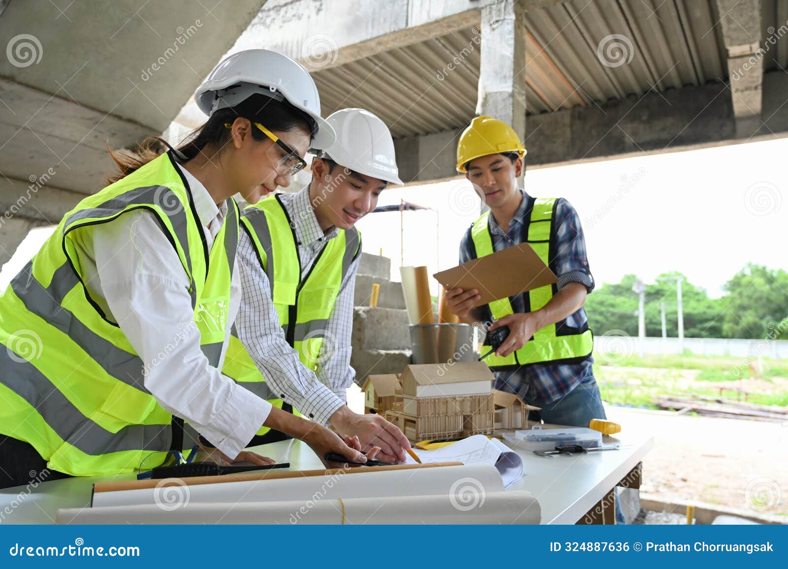 A Team of Construction Professionals in Safety Hard Hats Planning ...