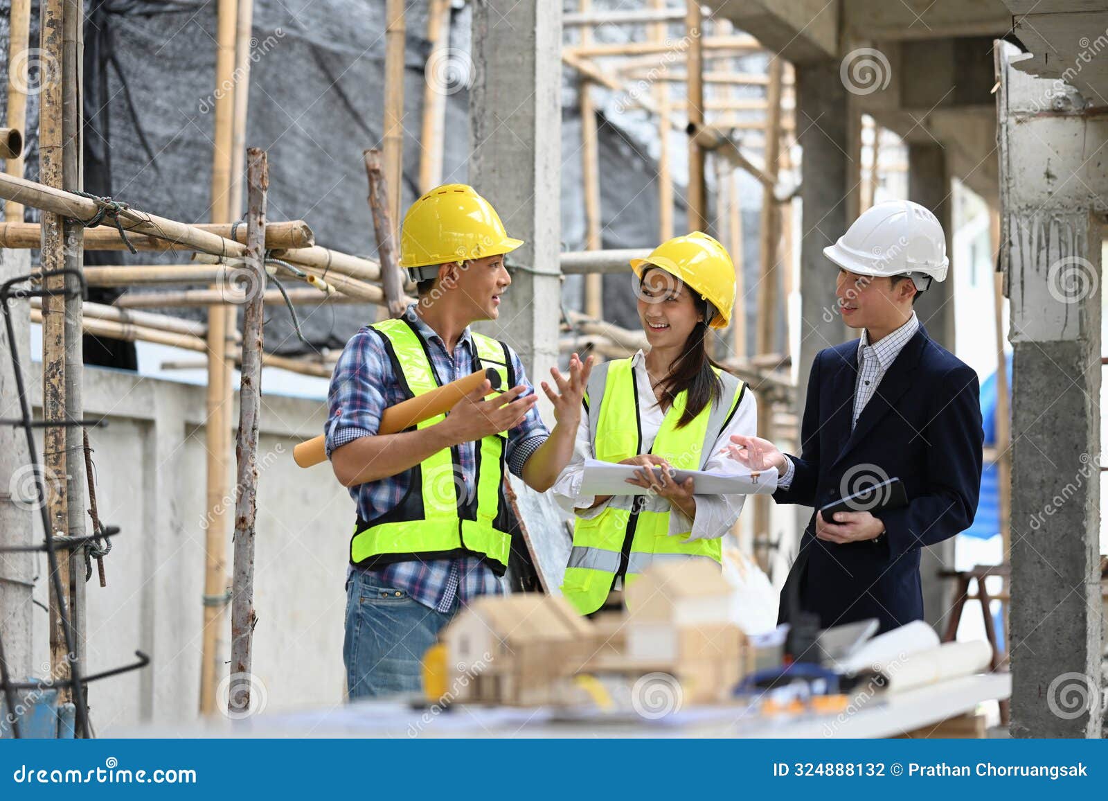A Team of Construction Professionals in Safety Hard Hats Planning ...