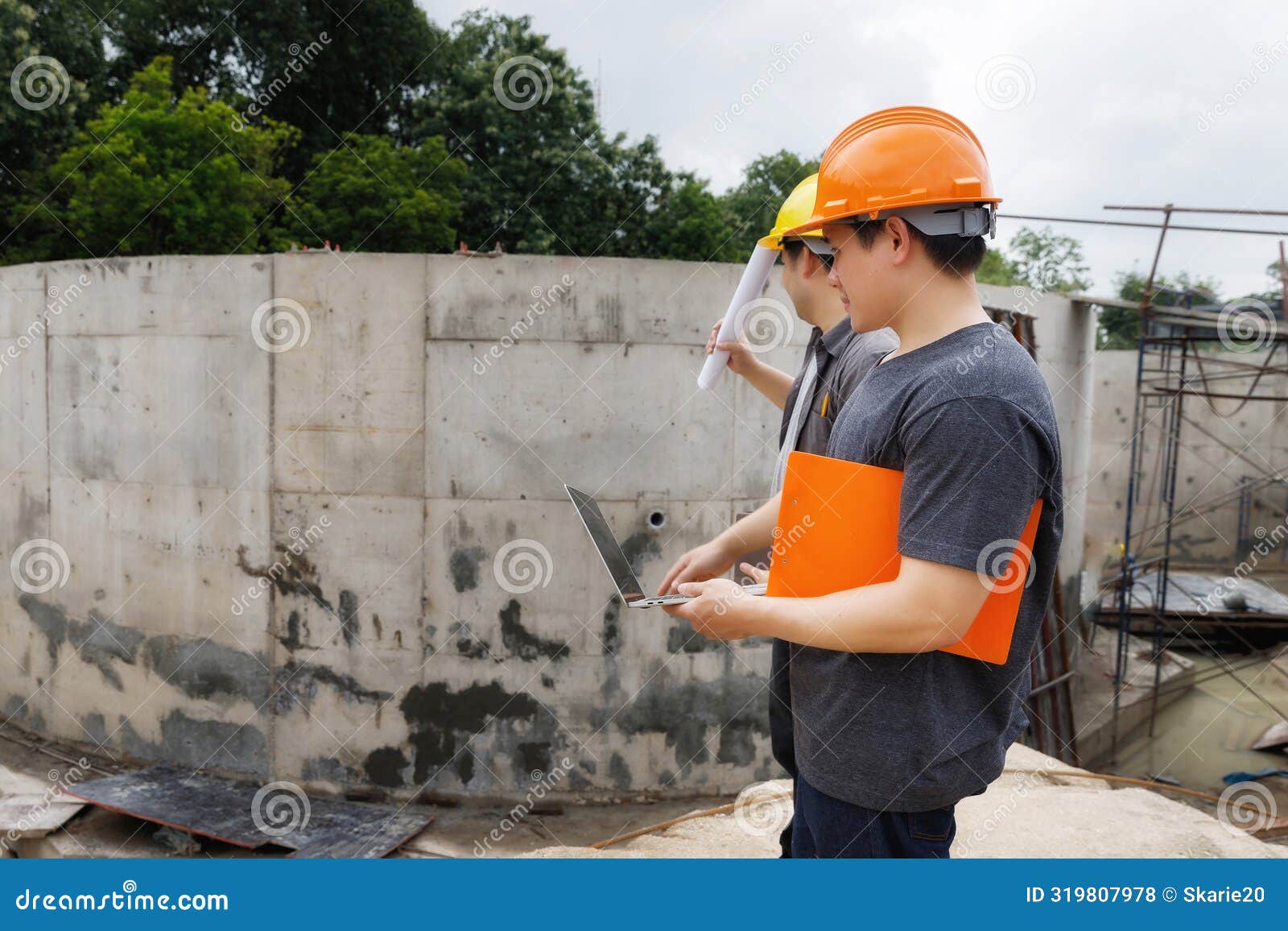 Team of Construction Workers Discussing Project Details with Blueprint ...
