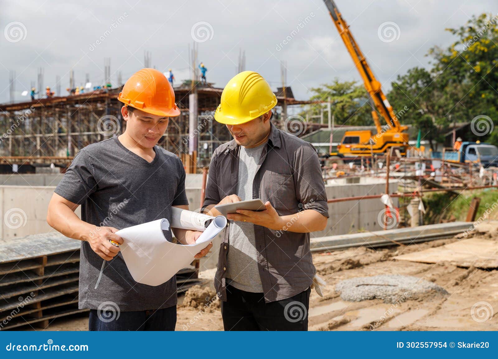 Team of Construction Workers Discussing Project Details with Blueprint ...