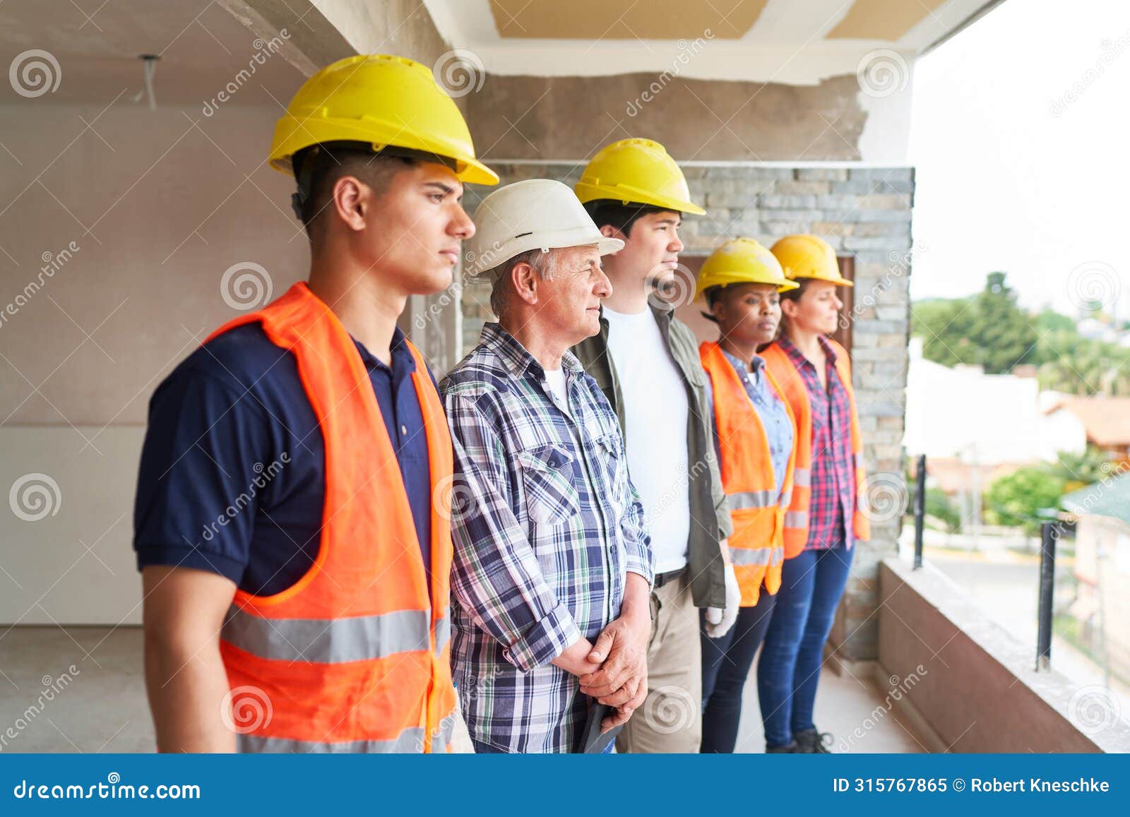 Team of Construction Workers Wearing Safety Workwear Looking Out from ...