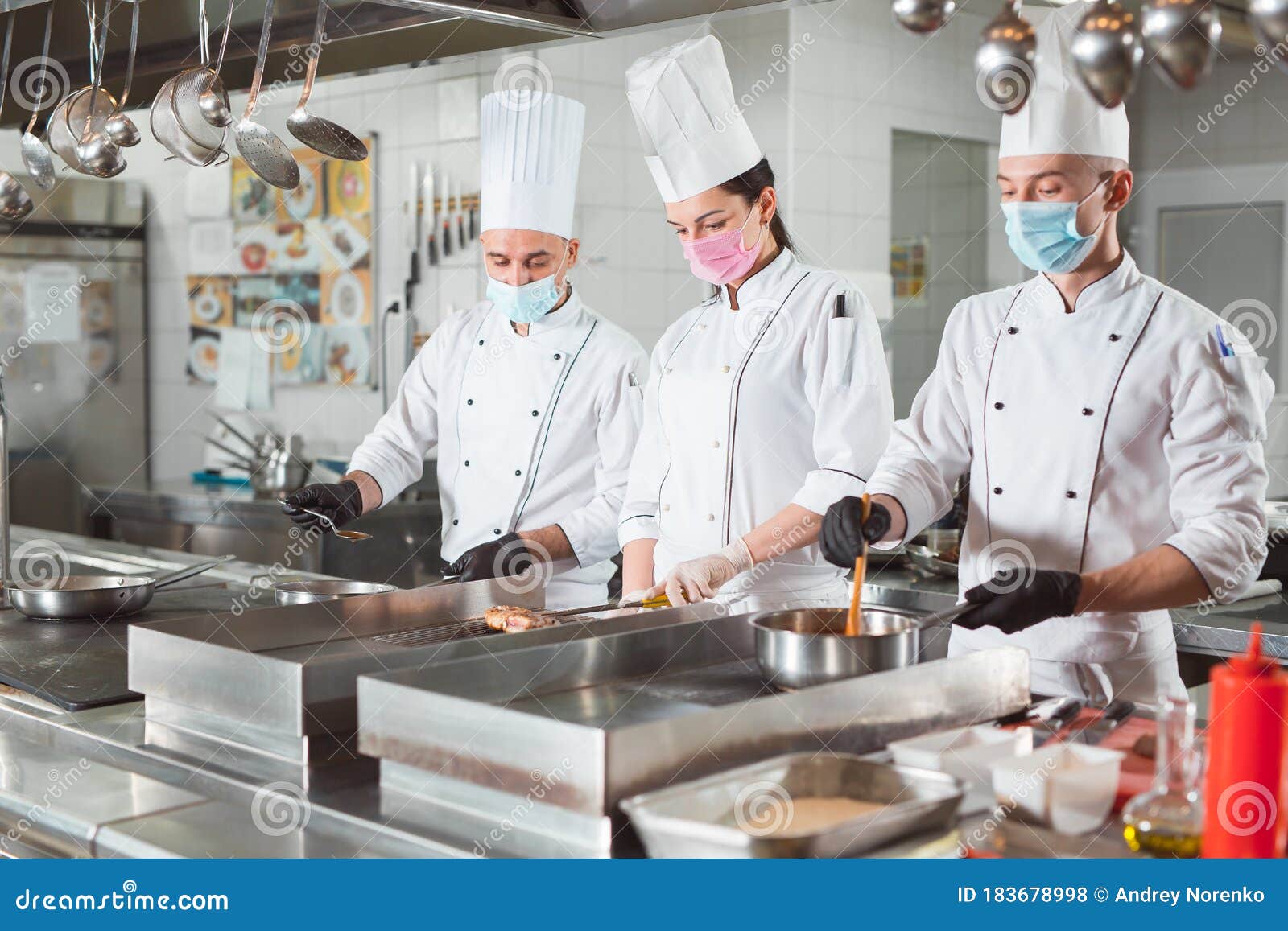 Team of Cooks Cooks in a Restaurant Stock Photo - Image of mask ...