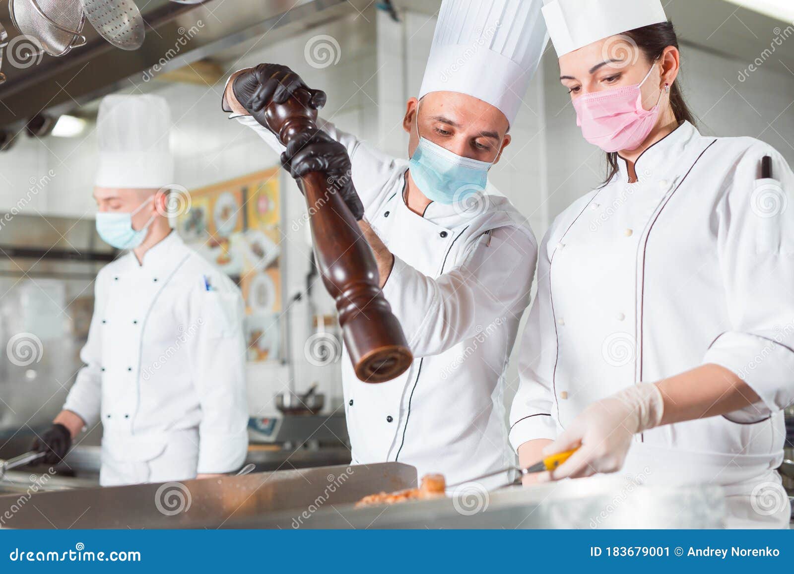 Team of Cooks Cooks in a Restaurant Stock Image - Image of dish, masks ...