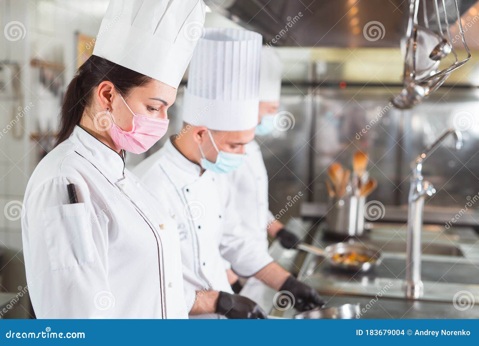 Team of Cooks Cooks in a Restaurant Stock Photo - Image of masks ...