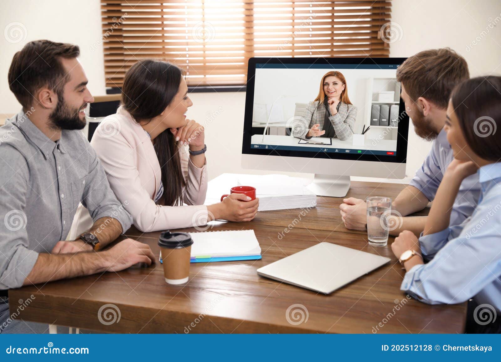 Team of Coworkers Having Video Chat with Boss in Office Stock Photo ...