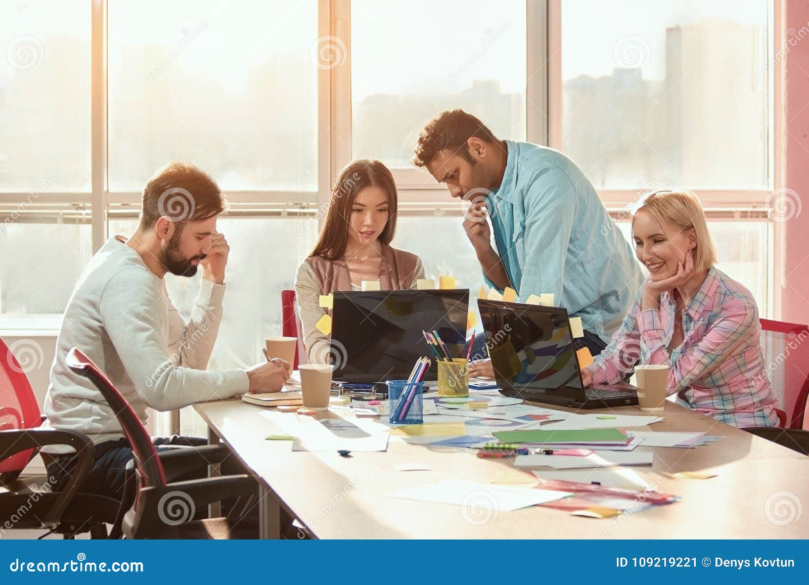 Team of Creative Designers Working on a Common Project in a Design ...