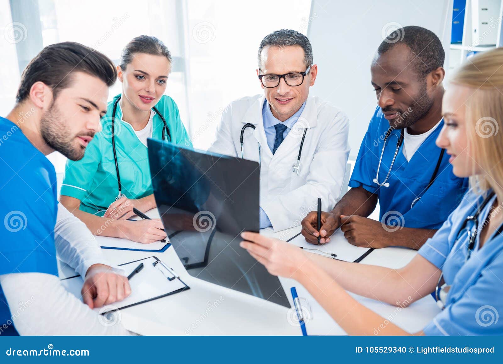 Team of Doctors Discussing X-ray Scan Stock Photo - Image of doctors ...