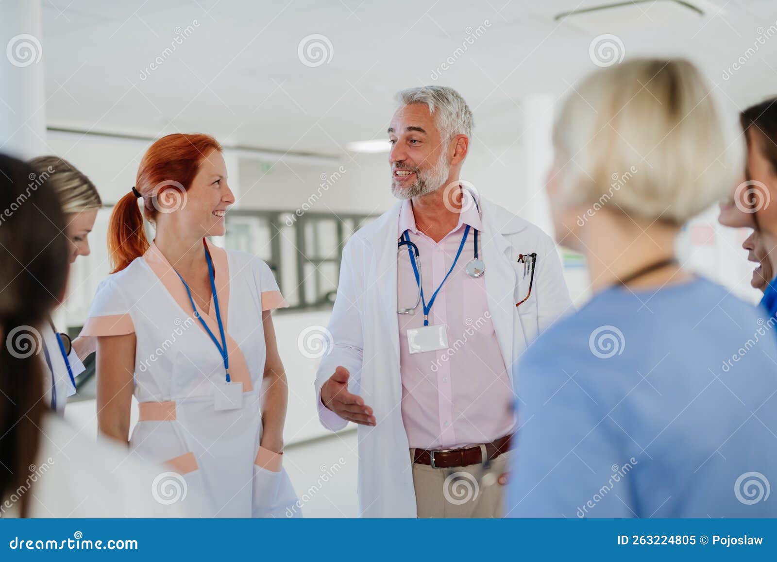 Team of Doctors Discussing Something at Hospital Corridor. Stock Image ...