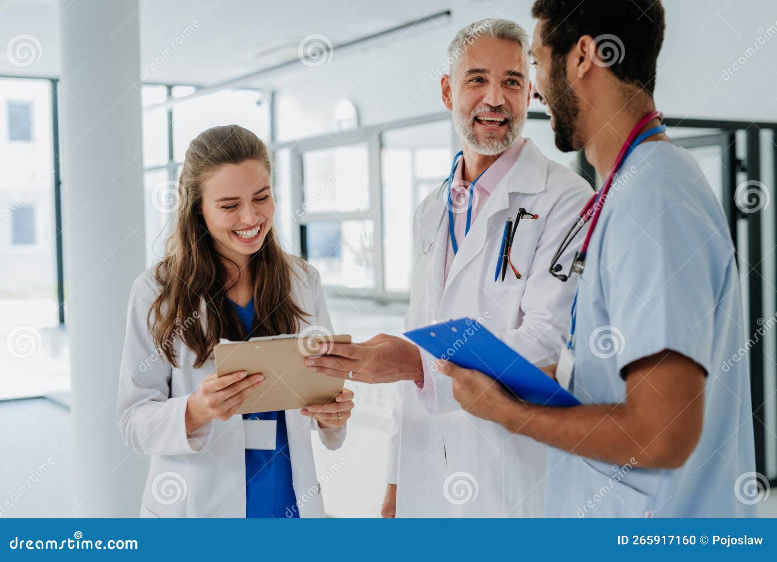 Team of Doctors Discussing Something at Hospital Corridor. Stock Photo ...