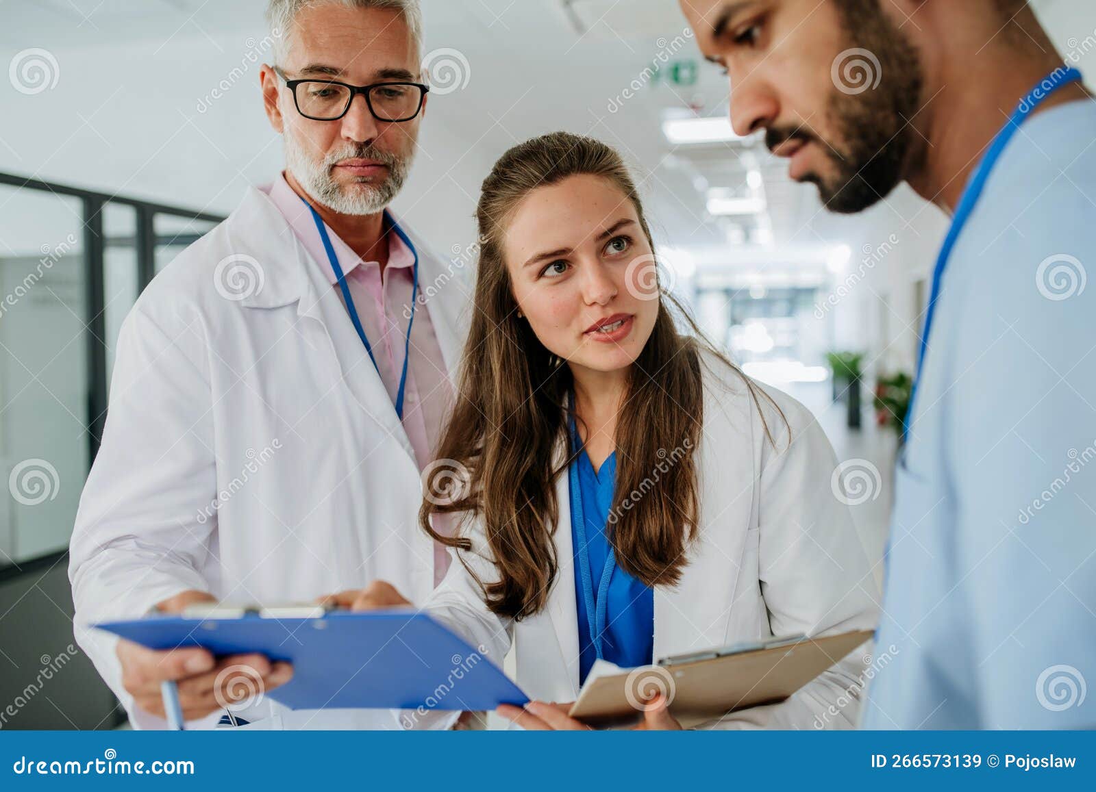Team of Doctors Discussing Something at Hospital Corridor. Stock Image ...