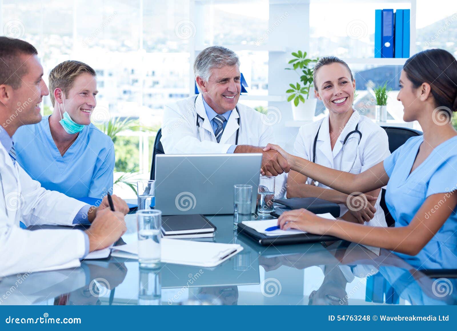 Team of Doctors Having a Meeting Stock Photo - Image of computer, coat ...