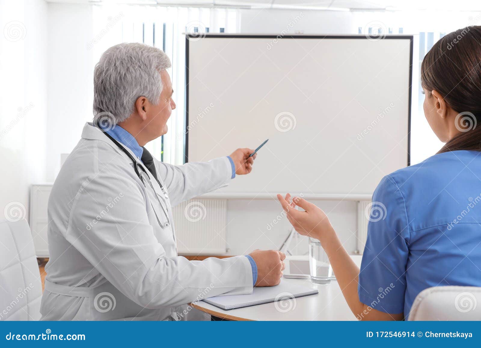Team of Doctors Looking at Projection Screen Stock Photo - Image of ...