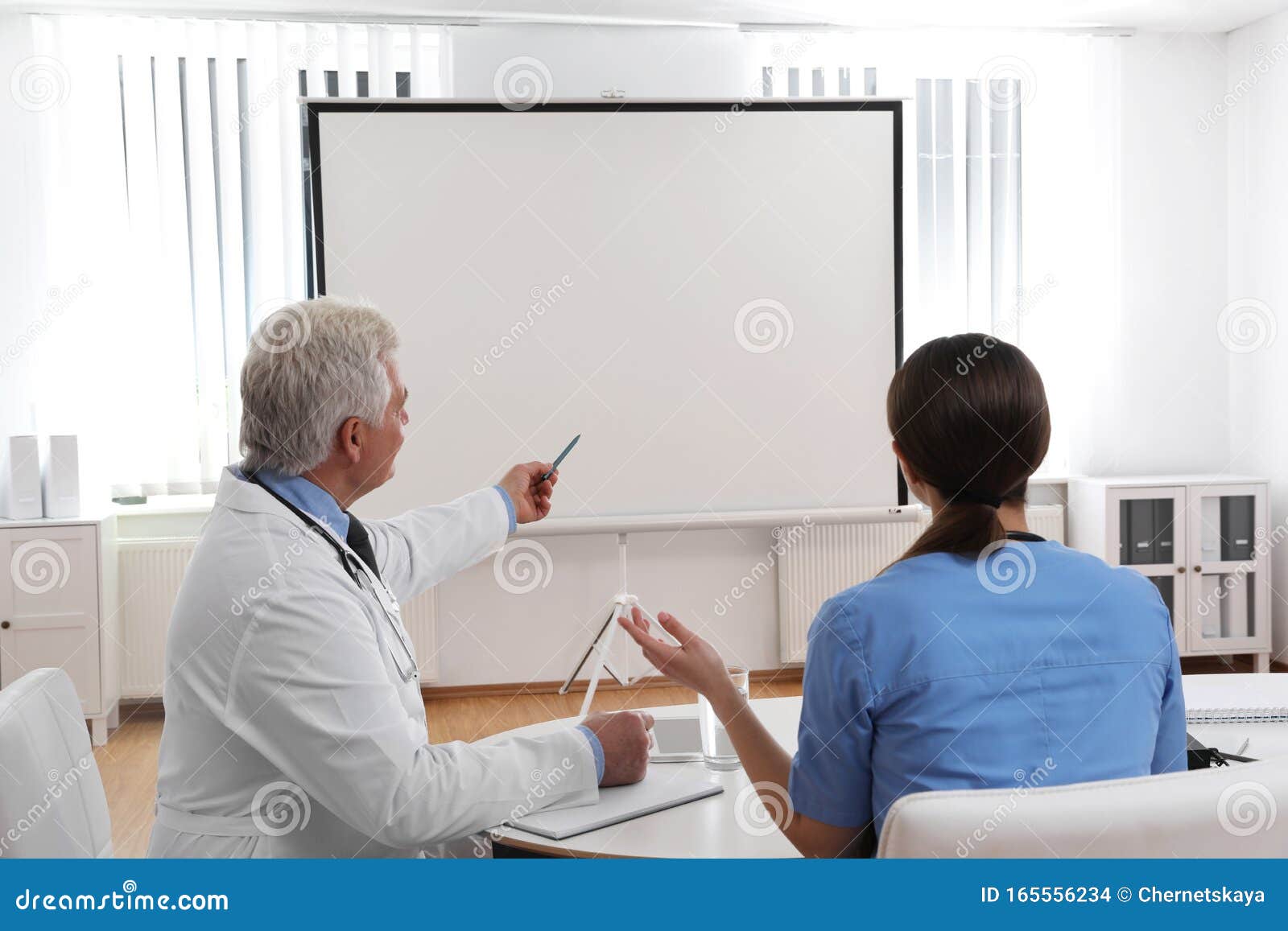 Team of Doctors Looking at Projection Screen Stock Photo - Image of ...