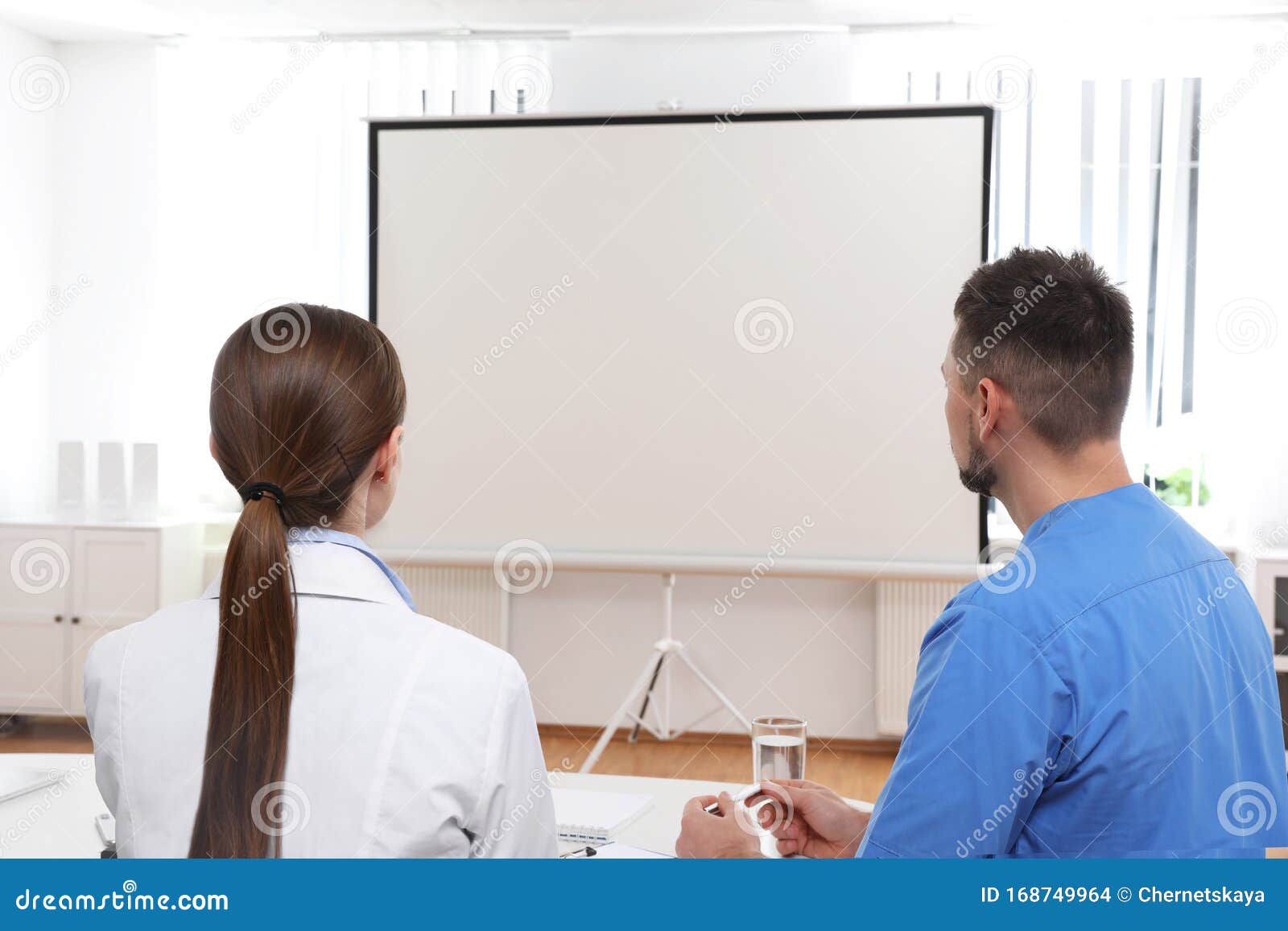 Team of Doctors Looking at Projection Screen Stock Photo - Image of ...