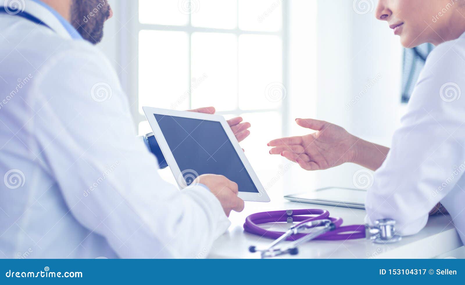 Team of Doctors Sitting at Table in Clinic Stock Image - Image of ...
